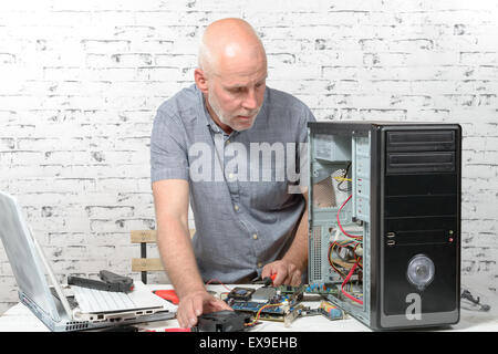 a technician repairing a computer with different tools Stock Photo - Alamy