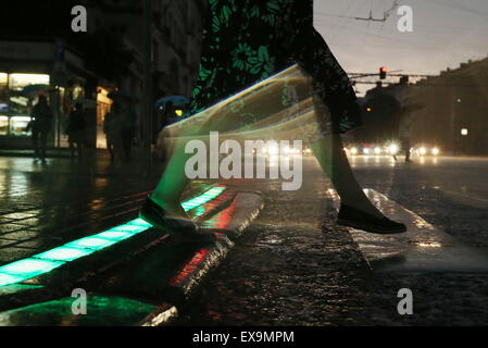At the pedestrian crossing a modern traffic light is installed which ...