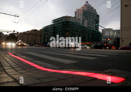 At the pedestrian crossing a modern traffic light is installed which ...