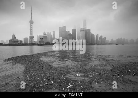 China, Shanghai, Vast pool of trash floats past skyline of Pudong ...