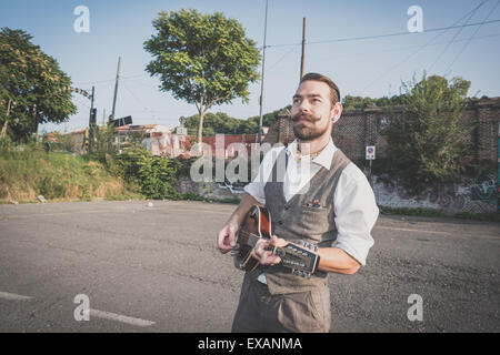 handsome big moustache hipster man playing mandolin in the city Stock ...