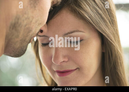 Two women nuzzling foreheads Stock Photo - Alamy