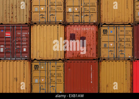 Various brands and colors of shipping containers stacked Stock Photo ...