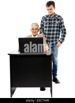 Grandson is teaching his grandfather to use laptop computer Stock Photo ...