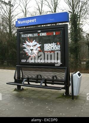 Commuters wait in front a departure board at a train station in Cologne ...