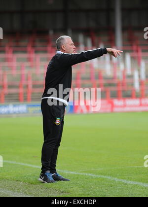 Wrexham, UK. 11th July, 2015. Wrexham manager Gary Mills in the dugout ...