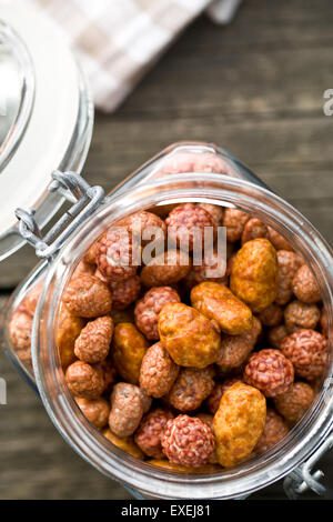 various sugared nuts in jar on old wooden table Stock Photo - Alamy
