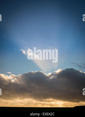 Shafts of sun light above a cloud near sunset Stock Photo - Alamy