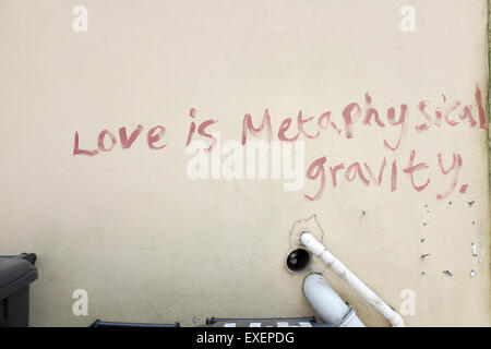 Graffiti in Frome, Somerset - Love is Metaphysical Gravity Stock Photo ...