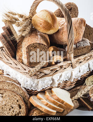 Wicker basket sliced bread rye ears on burlap background Stock Photo ...
