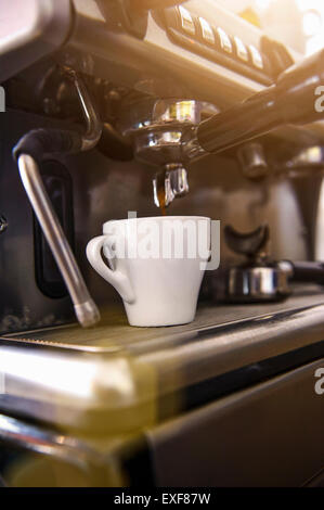 Coffee machine in kitchen with nobody in it. Modern dining room with ...