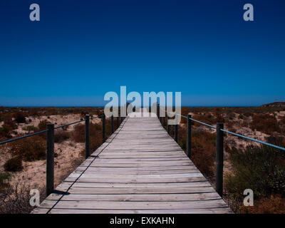 pedestrian path for access to the sand of the beach protected by wooden ...
