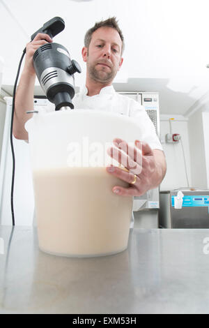 making ice cream in a professional kitchen, mixing it, adding the ...