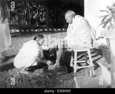 Kasturba Gandhi washing Mahatma Gandhi's feet at Bardoli ; 1939 ; India ...