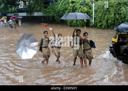 Children walking to school in the rain Stock Photo - Alamy