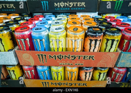 A display of Monster energy drinks cans on the shelves of a grocery ...