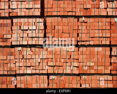 Just made red bricks stacked in several rows for sale Stock Photo - Alamy