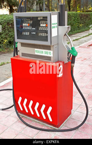 Vintage red fuel pump with White Rose logo in front of a gas service ...