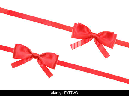 two big red satin bows and two diagonal ribbons isolated on horizontal ...