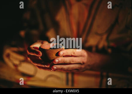 A Shipibo curandero shaman holds a cup of Ayahuasca an indigenous ...