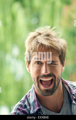 High-spirited good-looking man greeting someone on Skype Stock Photo ...