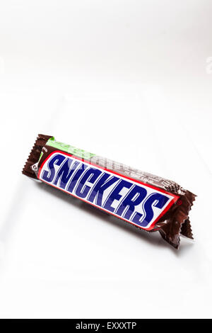 Snickers chocolate bar on white background with open cut up bar by the ...