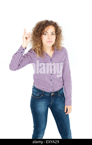 Beautiful young displeased woman with different scattered clothes ...