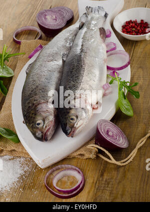 Rainbow trout on wooden table. Selective focus Stock Photo - Alamy
