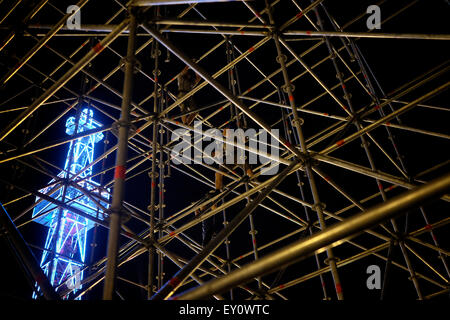Workers on reinforcing steel rods constructing a huge lighting stand ...