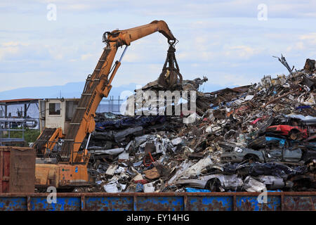 Crane loading scrap metal onto cargo ship, Newhaven, Sussex, UK Stock ...