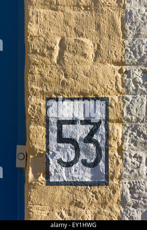 Number 53, fifty-three, white digits on a blue plate, exterior wall ...