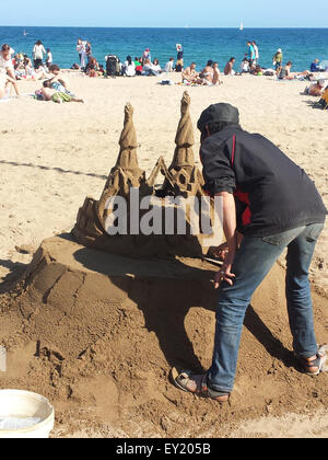 man building sandcastle Stock Photo - Alamy