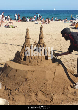 Man building a sand castle at the beach Stock Photo - Alamy