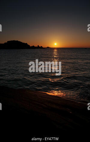 Sunset over Guernsey beach Stock Photo - Alamy