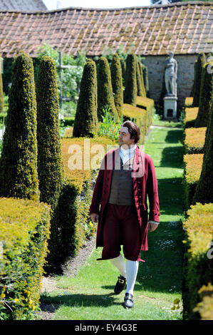 An opera singer strolls through the parterre garden at Garsington Manor ...