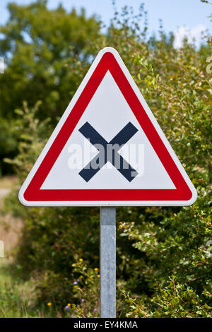 Triangular crossroads road sign on a country road junction Stock Photo ...