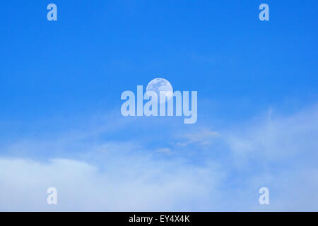 Moon rising above the clouds during a spring afternoon Stock Photo - Alamy