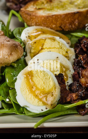 hard-boiled eggs with spinach salad, green beans and walnuts - closeup ...