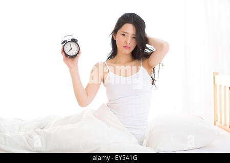 Young asian woman holding alarm clock screaming proud, celebrating ...