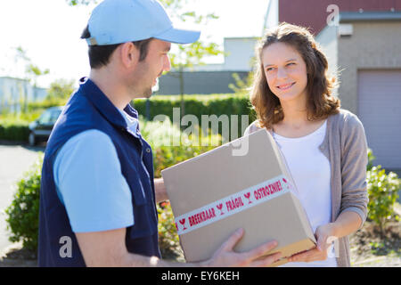 View of a Delivery man handing over a parcel to customer Stock Photo ...