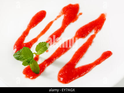 Strawberry drizzle sauce on plate Stock Photo - Alamy