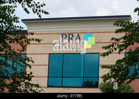 A logo sign outside of the headquarters of the PRA Group, Inc., also ...