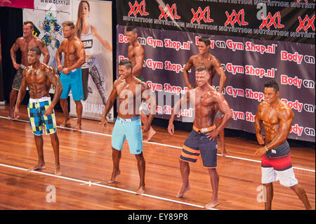 Male fitness contestants show their physique in a lineup comparison at ...