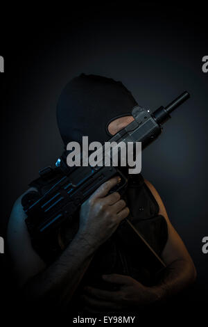 Criminal, Man wearing balaclavas and bulletproof vest with firearms ...