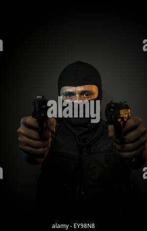 Man wearing balaclavas and bulletproof vest with firearms Stock Photo ...