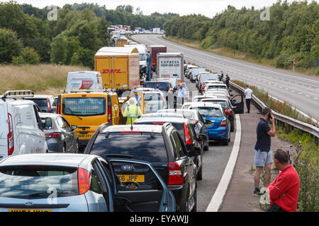 People Waiting By their Cars On The Motorway Whilst in Traffic Jam On ...