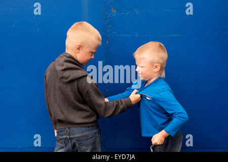 children bullying and fight between two angry aggressive brothers (kids ...