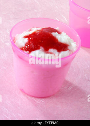 Creamy rice pudding with strawberry on wooden board Stock Photo - Alamy