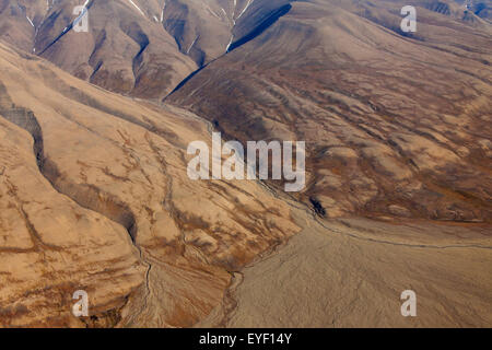 Aerial view of barren mountainside with deep gullies carved by water ...