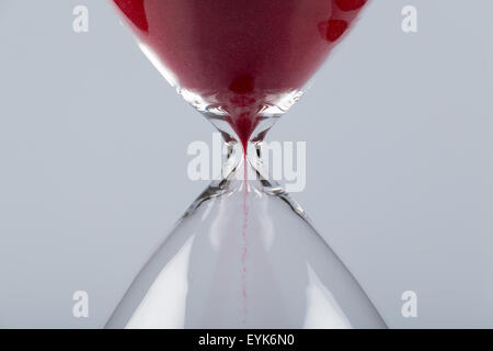 Hourglass - Grains of sand falling down Stock Photo - Alamy